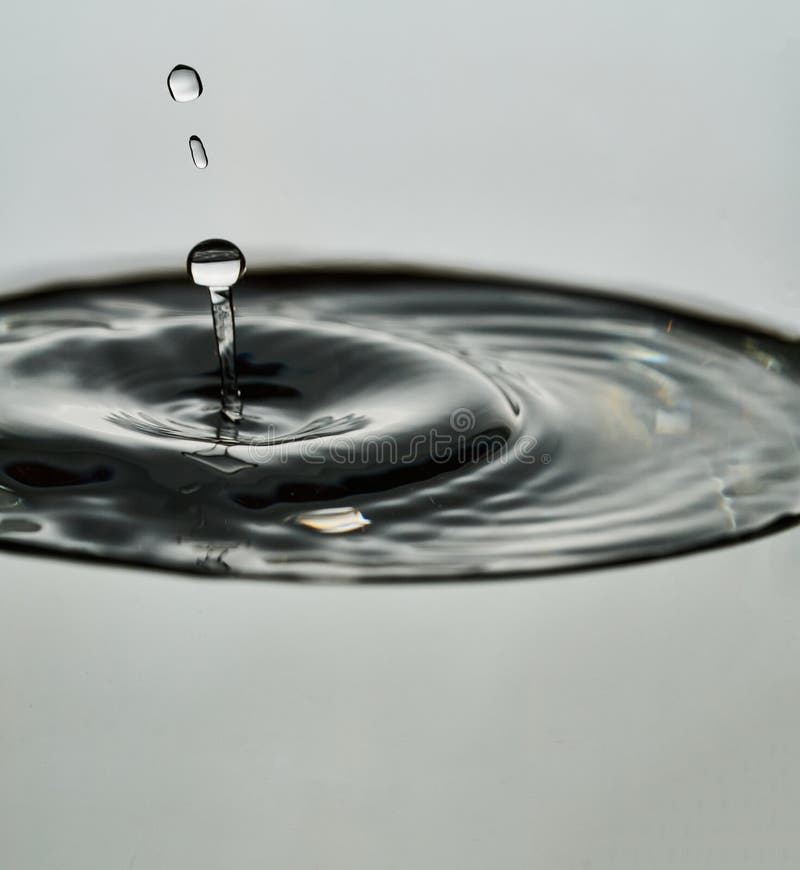 Water Drop Splash in a Glass Blue Colored Stock Image - Image of bright ...