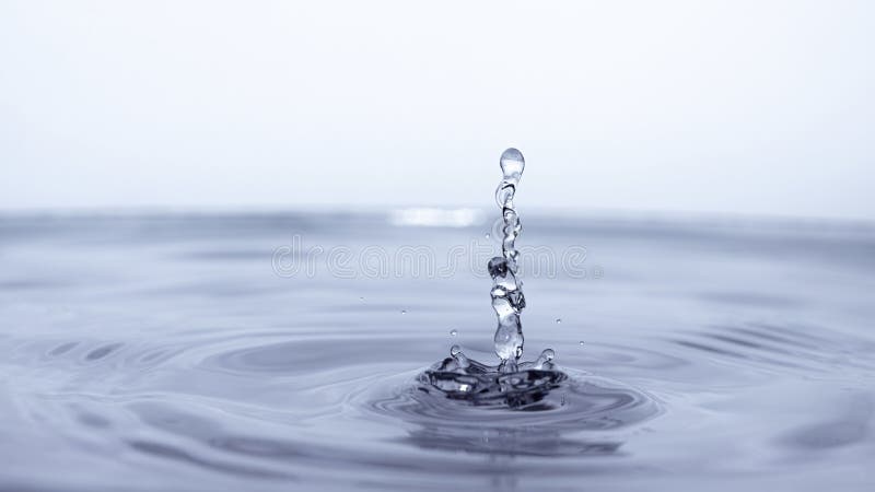 Water Drop Splash in a Glass Blue Colored Stock Image - Image of ...