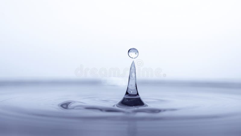 Water Drop Splash in a Glass Blue Colored Stock Photo - Image of drop ...