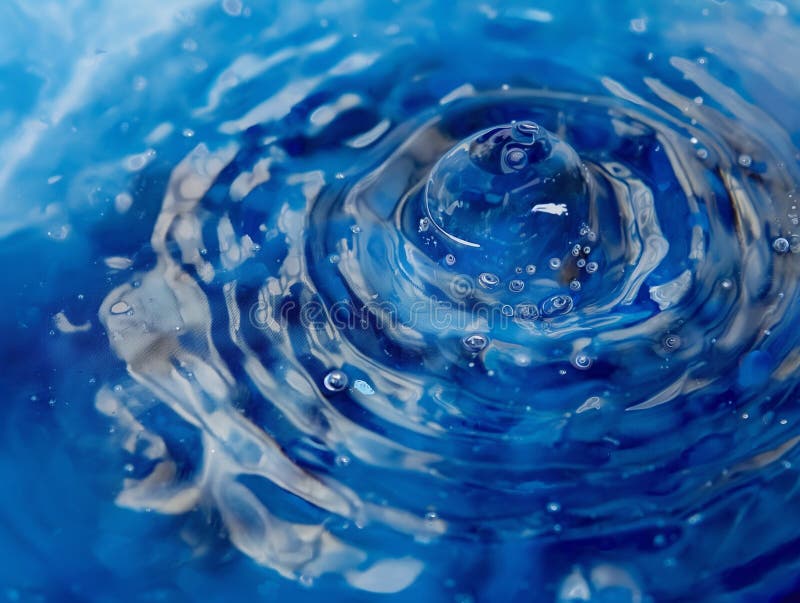 Water Drop Splash in a Glass Blue Colored Stock Photo - Image of ...