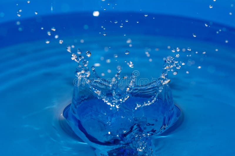 Water Drop Splash in a Glass Blue Colored Stock Photo - Image of impact ...
