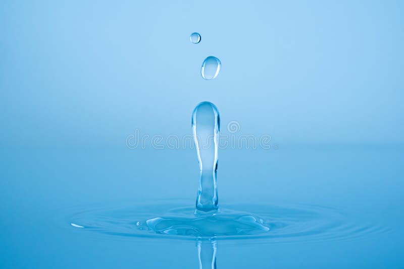 Water Drop Splashing into Blue Water Surface Stock Image - Image of ...