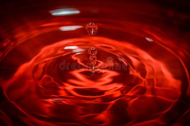 Water Drop an Waves with Red Background and Reflection Stock Photo ...