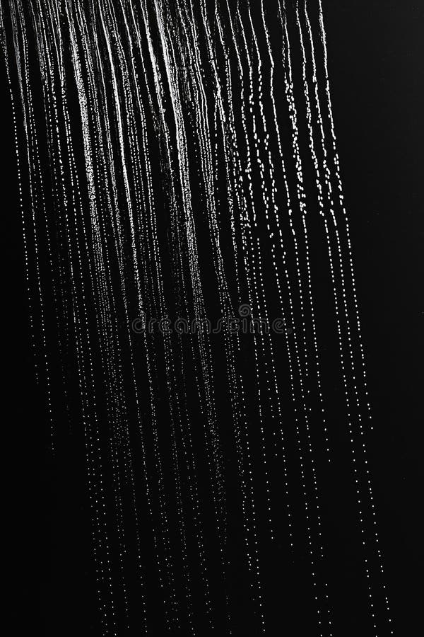 Water Droplets Cascade in a Mesmerizing Pattern Against a Dark ...