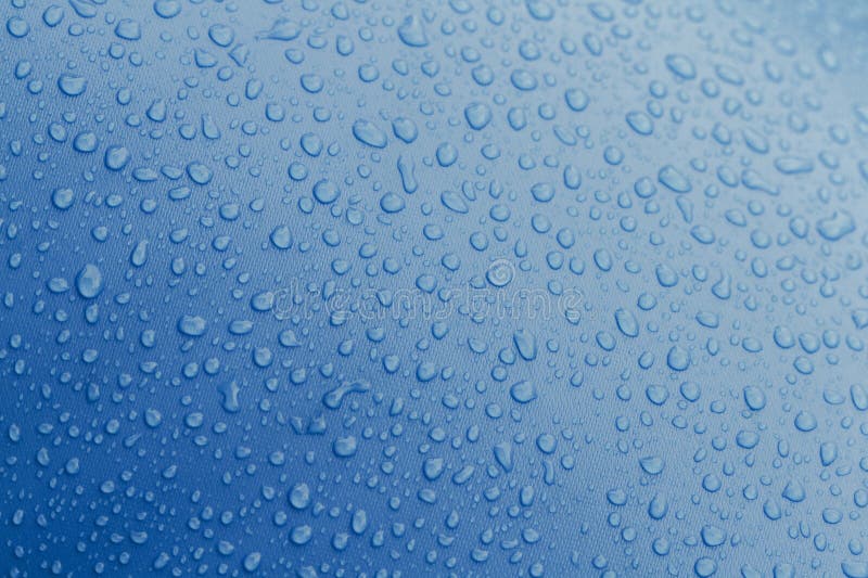 Water Droplets on Top a Textured Blue Surface Stock Photo - Image of ...