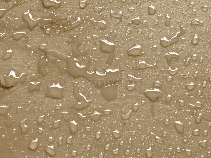 Water Drops on Almond Buff Colored Metallic Surface Stock Image - Image ...