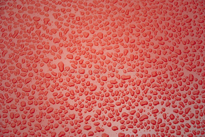 Water drops on red surface stock photo. Image of pattern - 186897676