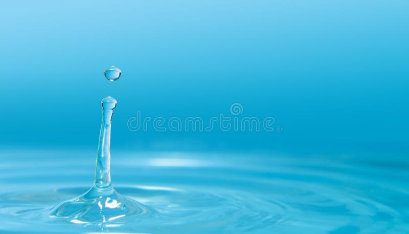 Water Drops Splashing on Water Surface Forming Waves Against Blue ...