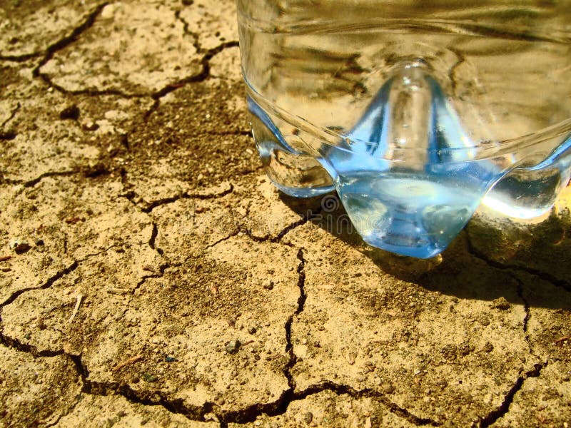 Water bottle on dry ground stock photo. Image of dehydrated - 11373940