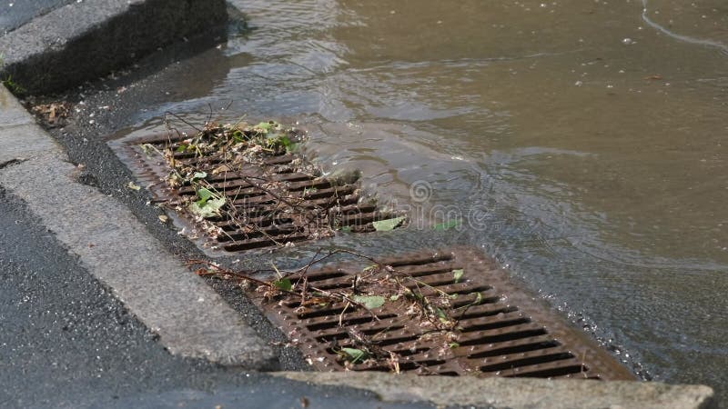 Storm Sewer. Light Rainfall. Puddle with Lights Reflection on City ...