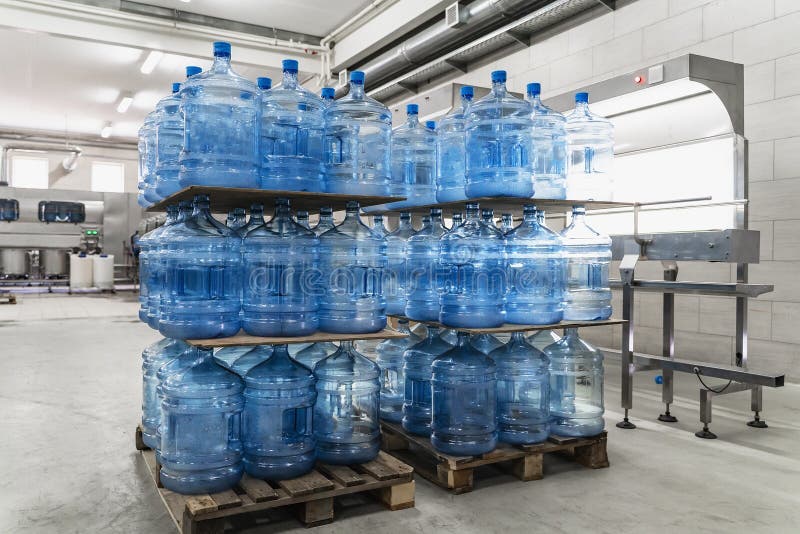 Water Factory. Pallets with Plastic Bottle or Gallon Inside Workshop ...