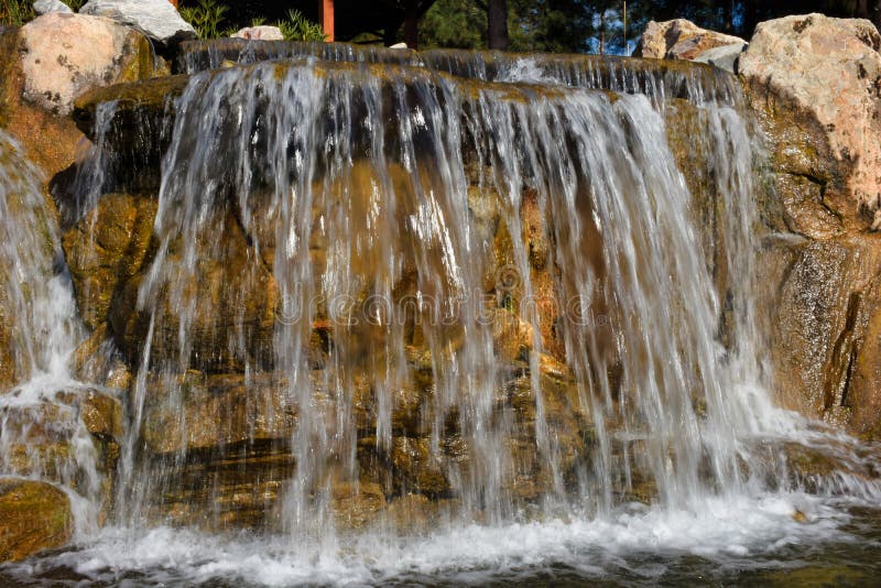 Close Up of a Water Fall Falling into a Pond Below Creating a Lot of ...