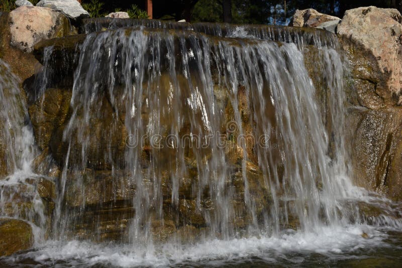 Close Up of a Water Fall Falling into a Pond Below Creating a Lot of ...