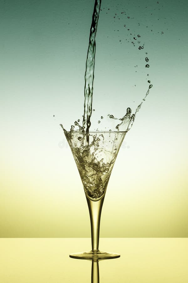 Water Fall into a Glass and Splash on Yellow and Green Background Stock ...