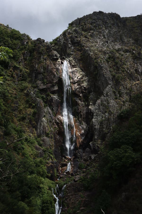 A Water Fall in the Mountains with Some Trees on Either Side Stock ...