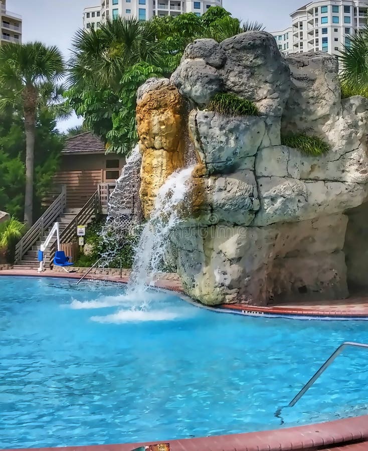 Water fall by pool editorial stock photo. Image of tropical - 61883418