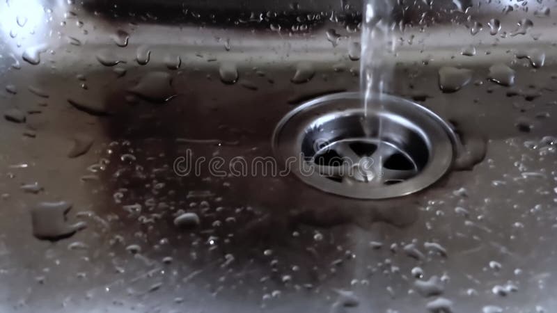 Water Falling in the Drain of a Metallic Kitchen Sink Stock Video ...