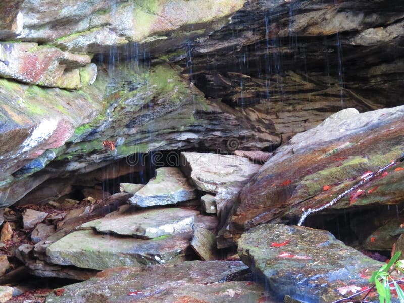 Water Falling in Front of Gray Angular Rock Cave Stock Image - Image of ...