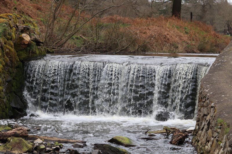 Water-falling Over the Edge of a Stone Wall Stock Photo - Image of ...