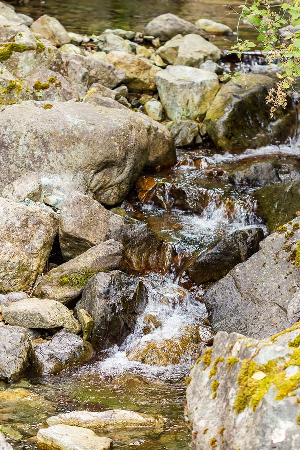 Water Falling Over Large Rocks and Small Pebbles Stock Image - Image of ...