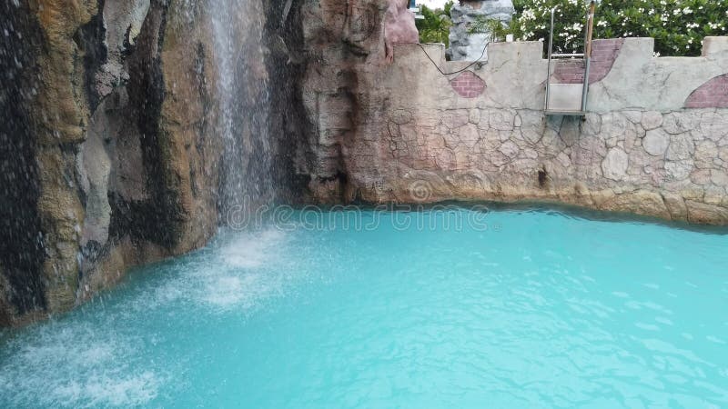 Water Falling Pouring into a Poolside from Stone Wall Stock Video ...