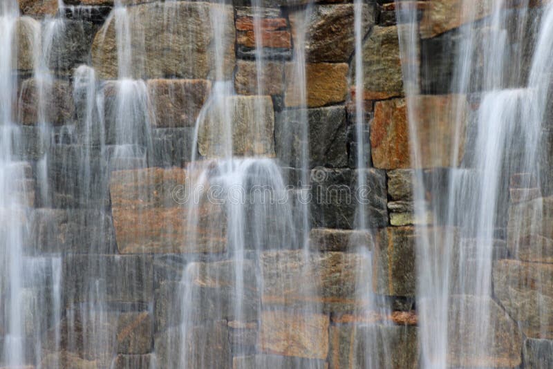 Water falling on rock wall stock photo. Image of black - 252201580