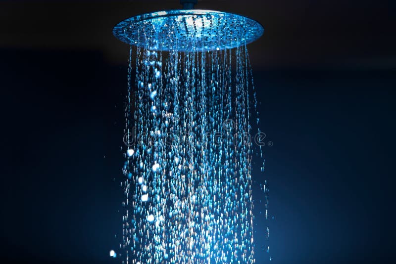 Water Falling from the Shower on a Dark Background with Blue Backlight ...