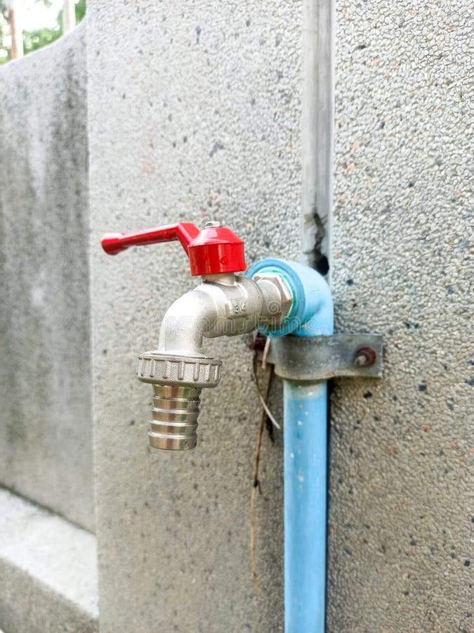 Water Faucet with Blue and Red Handle on Concrete Wall. Stock Photo ...