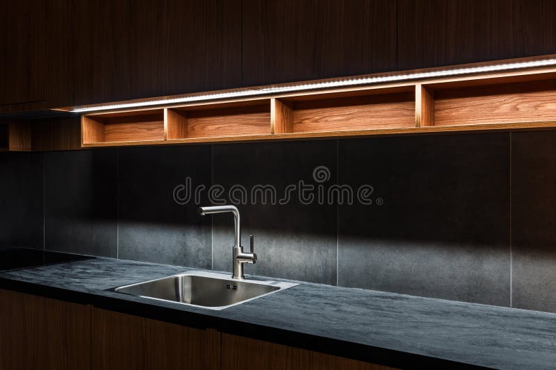 Water Faucet and Metallic Sink in Modern Sleek Kitchen with Led Strip ...
