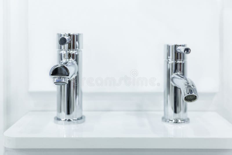 Water Faucets on the Sink in a Stylish White Interior. Exhibition of ...
