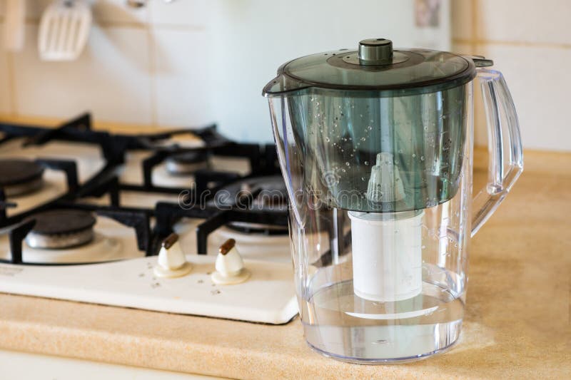 Water Filter Jug on Kitchen Table. Clean Water Concept Stock Photo ...