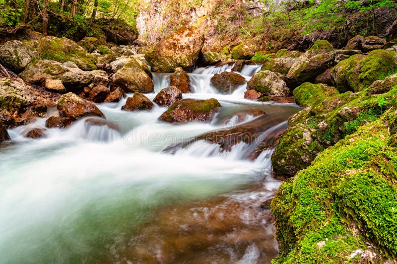 Water flowing around rocks stock photo. Image of long - 140755072