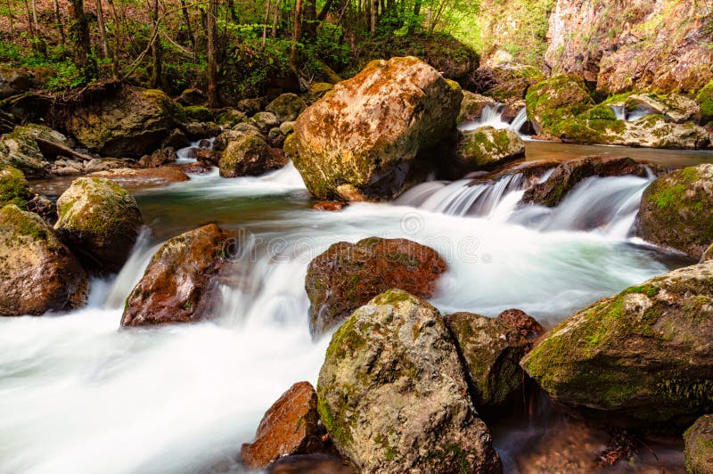 Water flowing around rocks stock photo. Image of fall - 140755124
