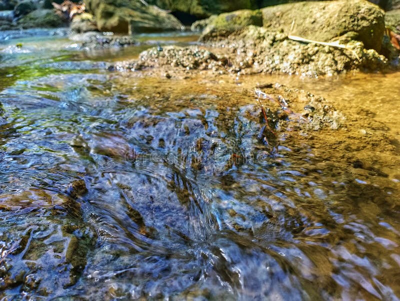 The Water is Flowing between Brownish Yellow Rocks Stock Photo - Image ...