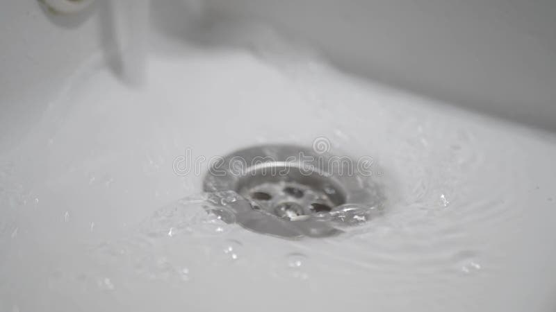 The Water Flowing Down A Sink Drain Illustrates Everyday Household