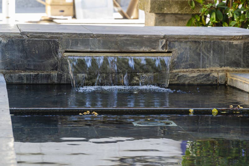 Water Flowing Gently from a Stone Feature into a Tranquil Outdoor Pool ...