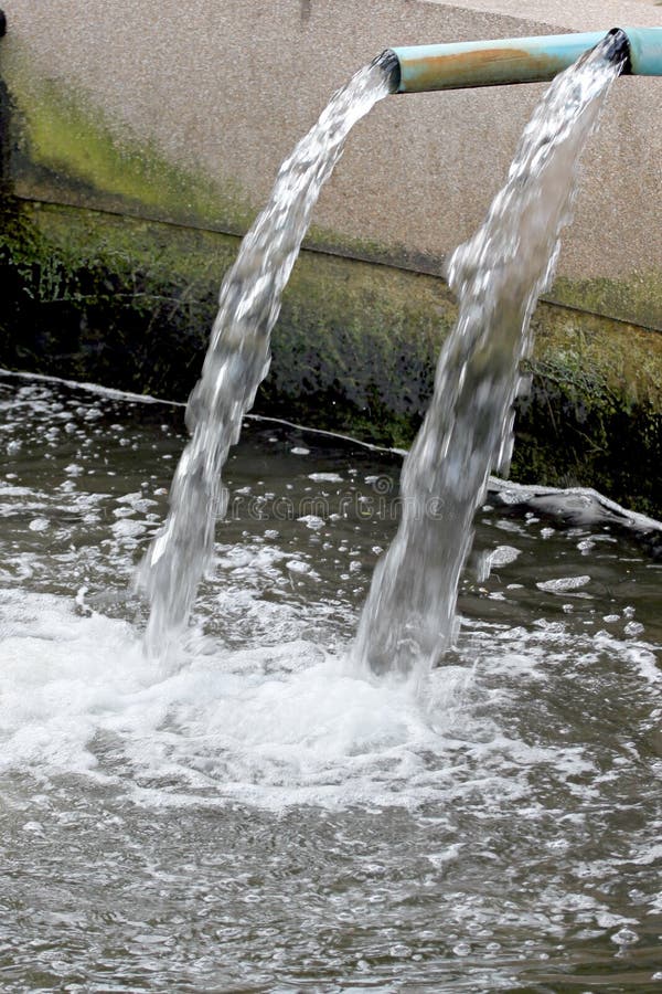 Water flowing out of pipe. stock photo. Image of drop - 35142530
