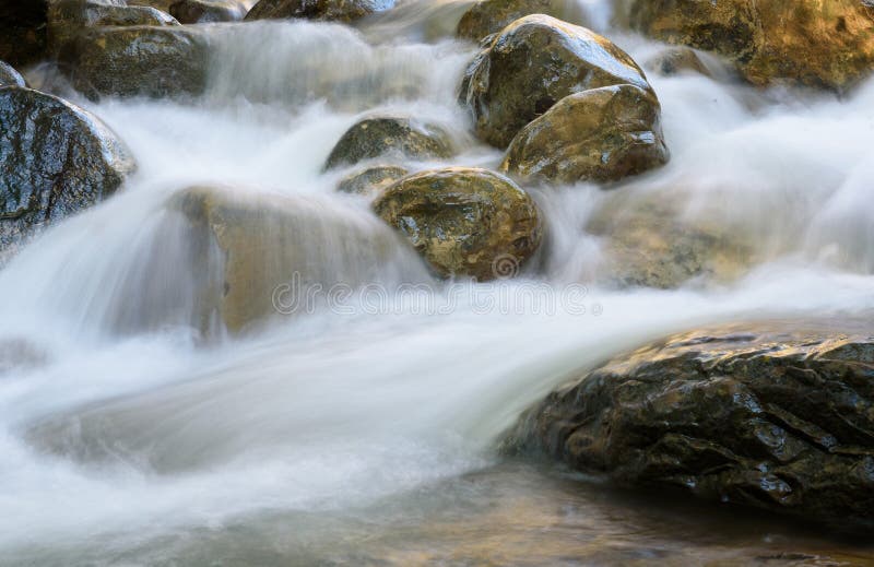 Water flowing over rocks stock photo. Image of moss - 371765584
