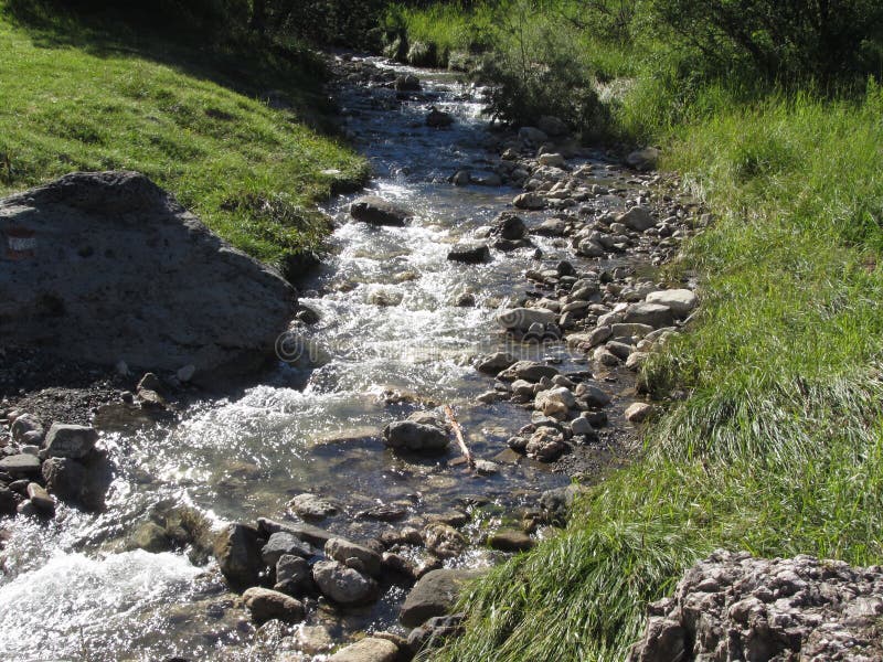 Water Flowing and Splashing Over Rocks in a Mountain River Stream Stock ...
