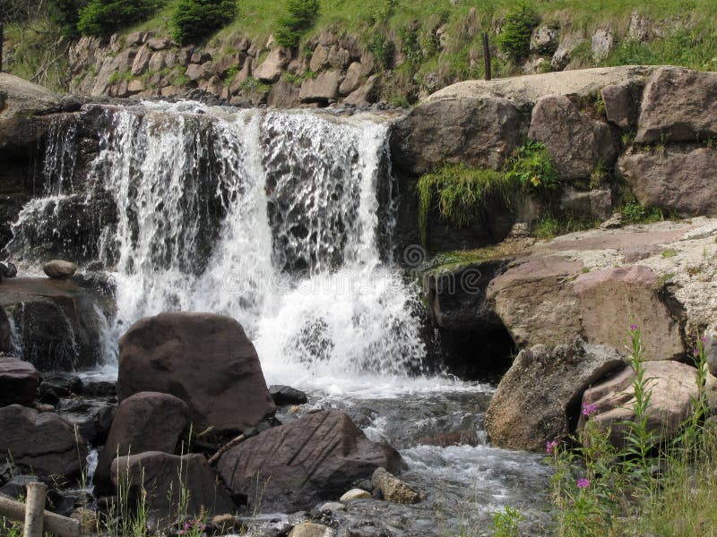 Water Flowing and Splashing Over Rocks in a Mountain River Stream Stock ...
