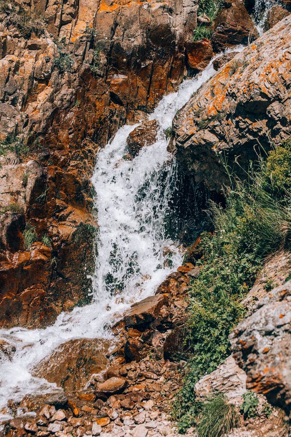 Water Flows Down from the Slopes of the Mountains. Small Waterfall ...