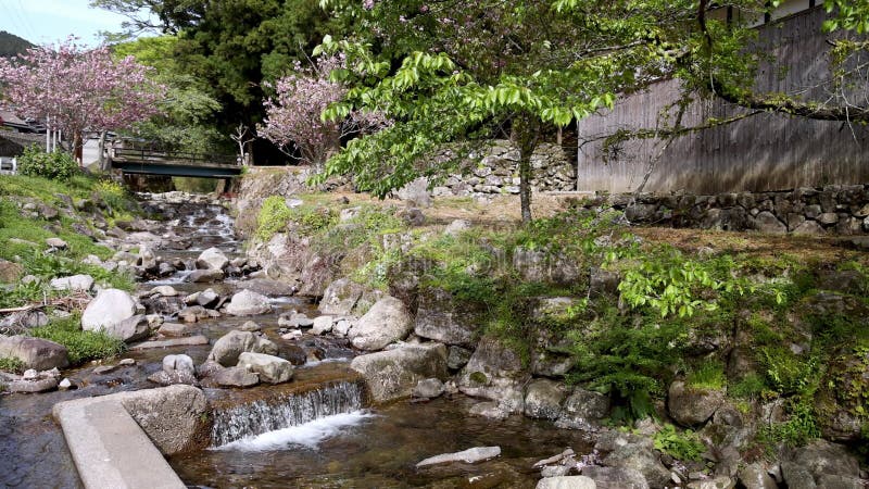 Water Flows Down Small Concrete Waterfall in Stone Covered Stream Stock ...