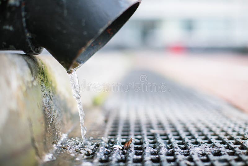Water Flows from the Drain Pipe To the Grate in the Ground Stock Image ...