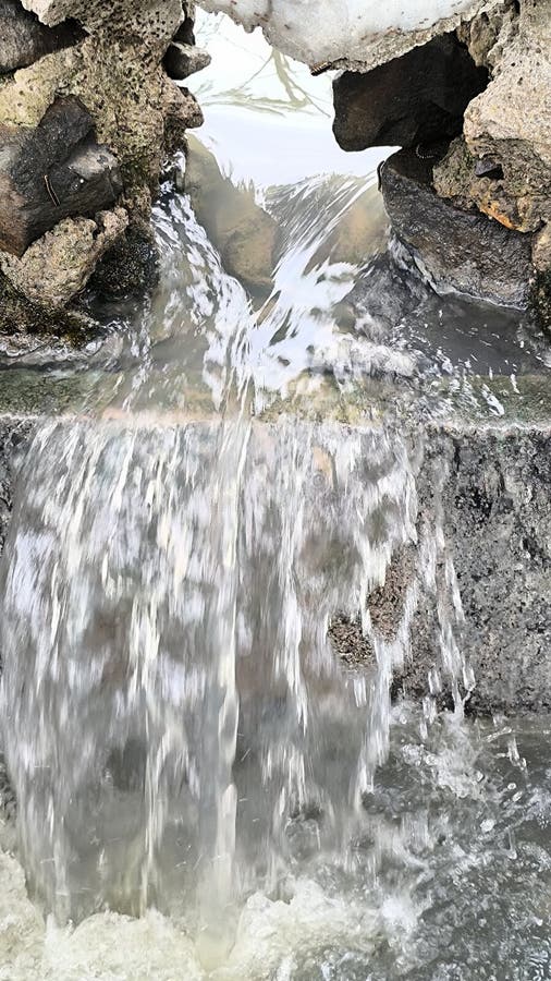 Water Flows from the Gaps in the Rocks Stock Photo - Image of water ...