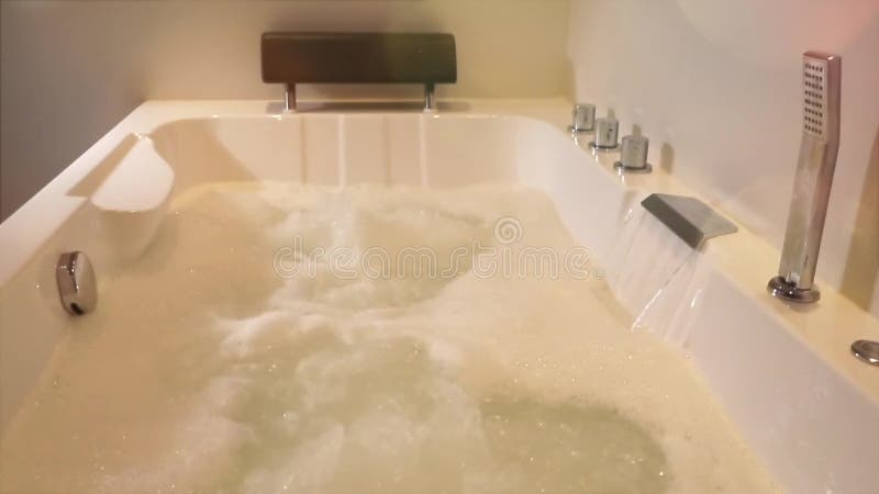 Water Flows in Jacuzzi. Spa Bathroom with Hydromassage and Foam Stock ...