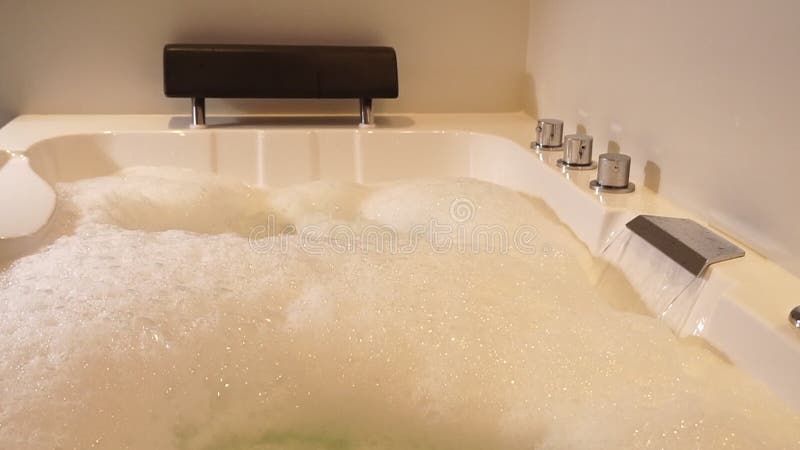 Water Flows in Jacuzzi. Spa Bathroom with Hydromassage and Foam Stock ...
