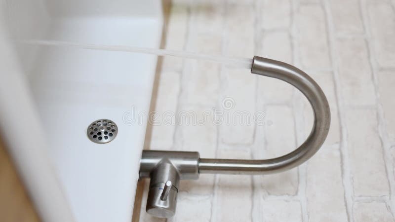 Water Flows from the Kitchen Faucet into the Sink. Improper Use of ...
