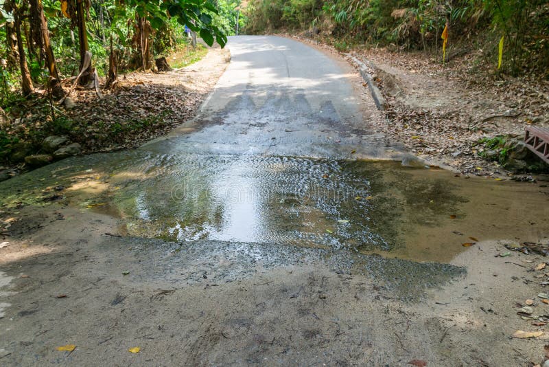The Water Flows through the Road Stock Image - Image of flow, cross ...