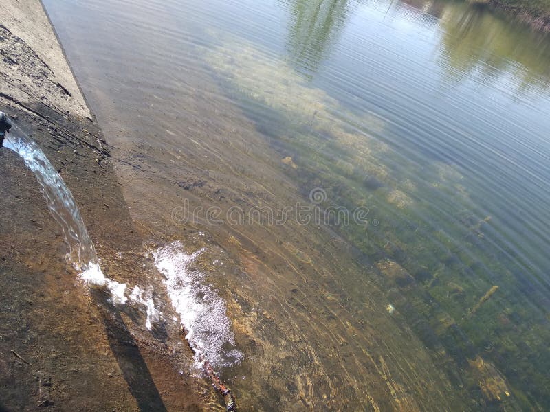 Water Flows Out of the Pipe Like a Small Waterfall Stock Photo - Image ...