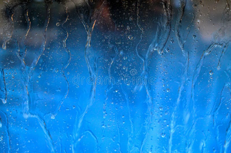 Water Flows Over the Blue Glass of the Window, Background, Stock Image ...